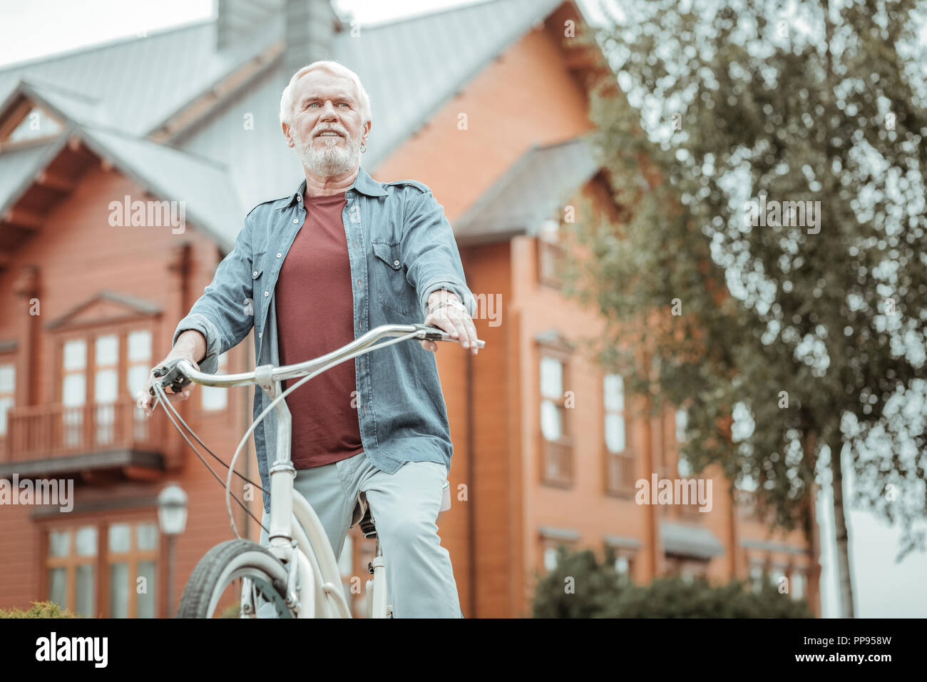 Serious male person riding his two-wheeled transport Stock Photo - Alamy