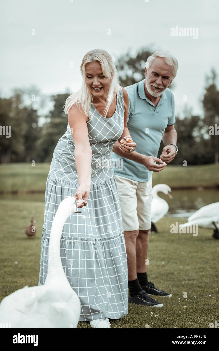 Cheerful woman bowing her head while looking forward Stock Photo - Alamy