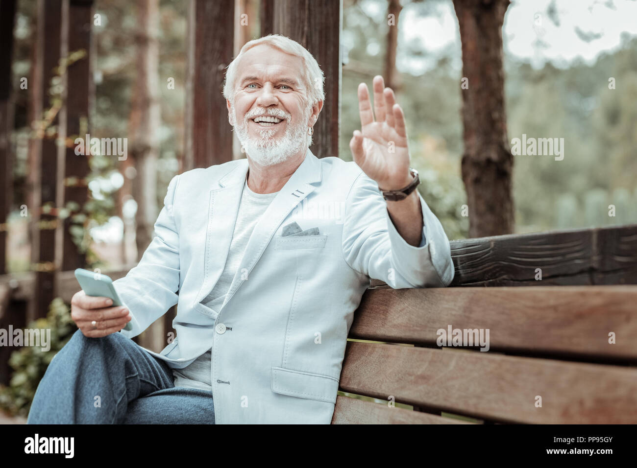 Senior man hand up waving hi-res stock photography and images - Alamy