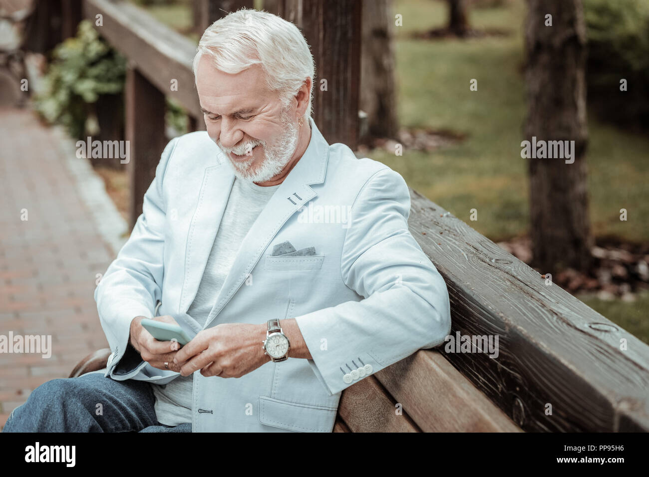 Cheerful male person keeping smile on his face Stock Photo - Alamy