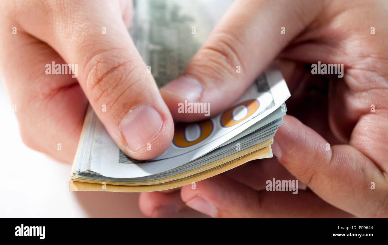 Closeup man counts money dollars hi-res stock photography and images - Alamy