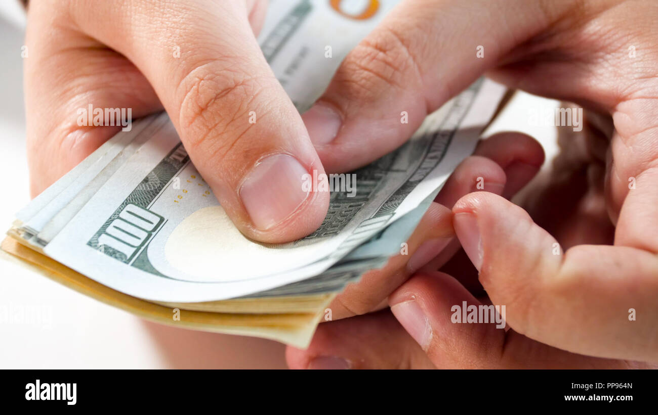 Hands counting hundred dollar bills hi-res stock photography and images ...