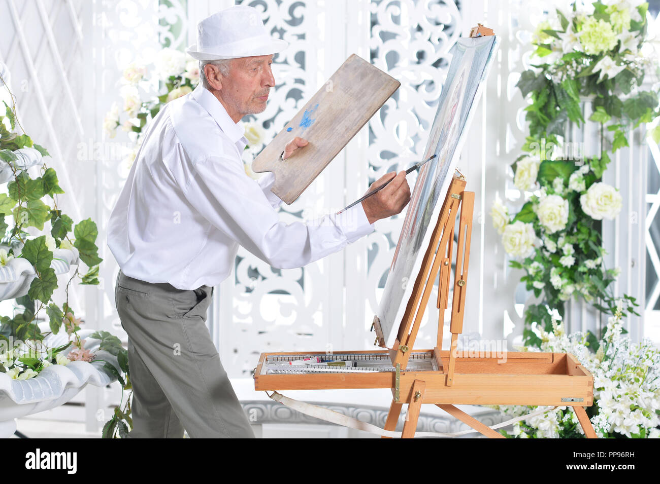 Portrait of senior man drawing picture in light room Stock Photo - Alamy