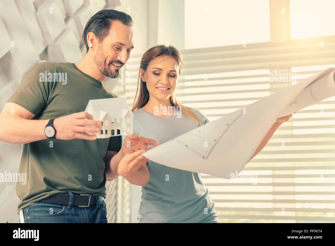Attentive male person checking his sketch with partner Stock Photo - Alamy