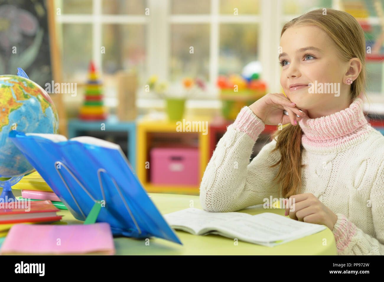 Portrait of little girl doing her homework Stock Photo - Alamy