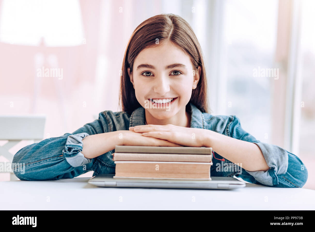 Amazing female person holding hands on books Stock Photo - Alamy