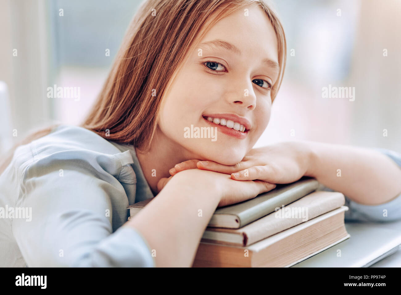 Beautiful little female putting chin on hands Stock Photo - Alamy