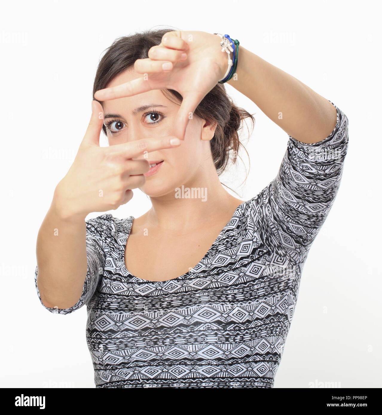Nice brunette making finger frame Stock Photo - Alamy