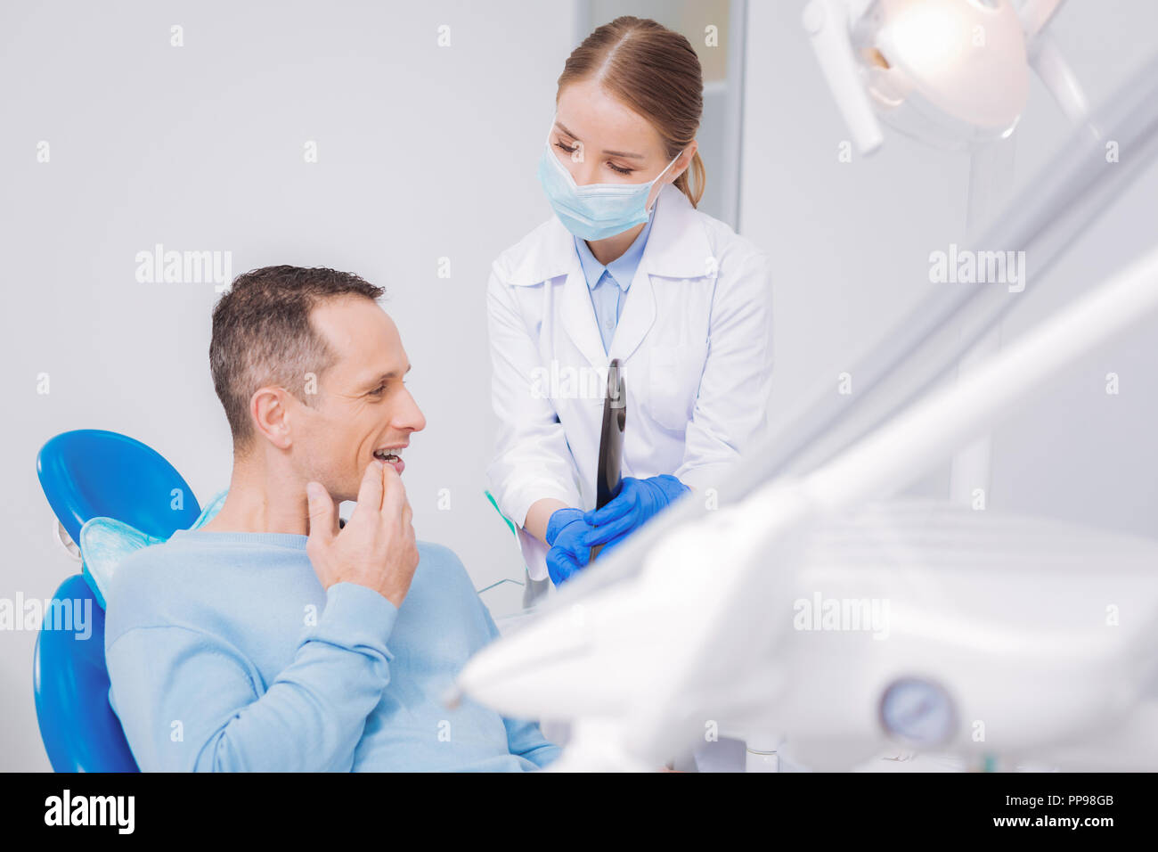 Touching her teeth hi-res stock photography and images - Alamy