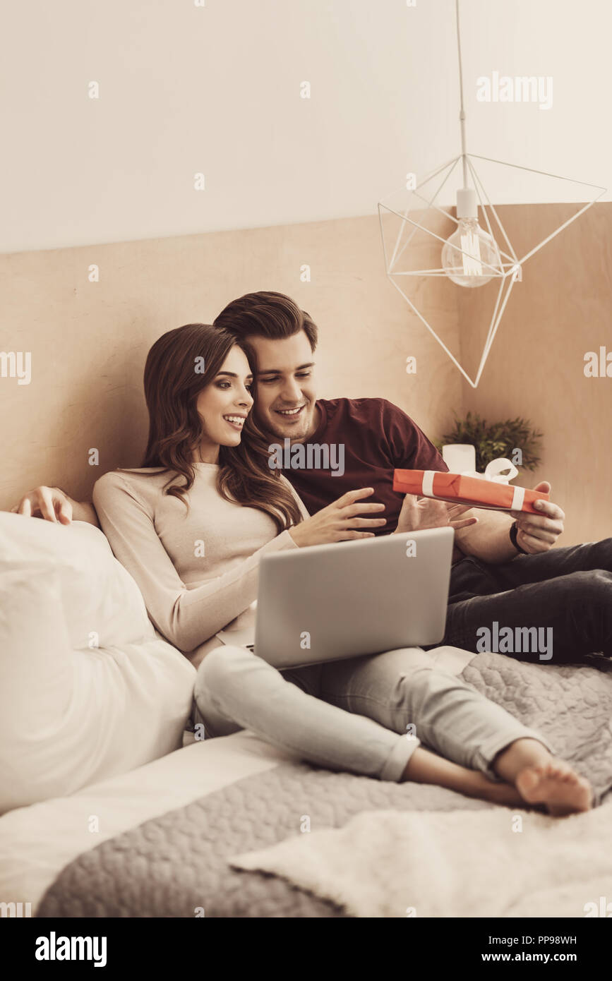 Laughing happy woman receiving cool present from her sweetheart Stock ...