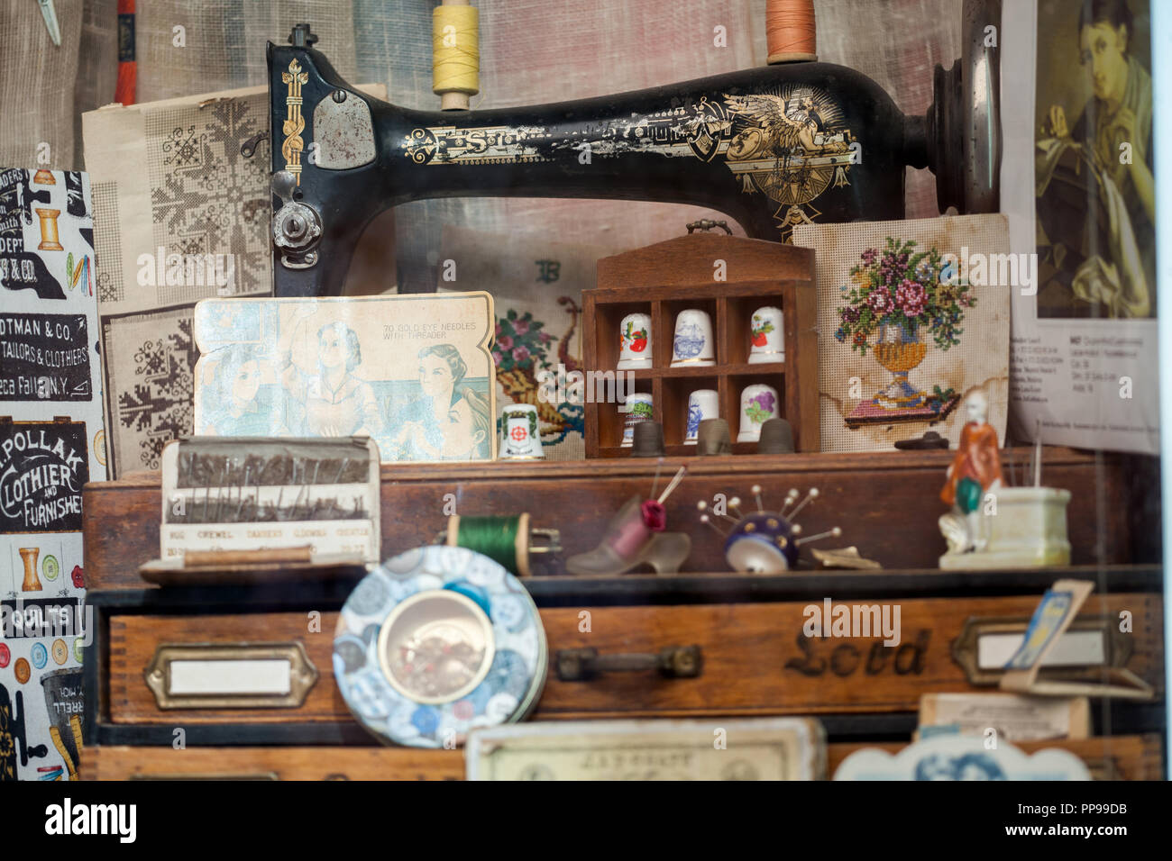 Shop window of sewing accessories. Old sewing machine. Antique sewing ...