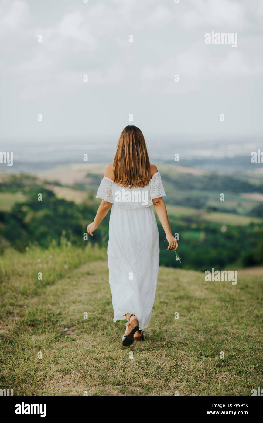 Back view at young woman relaxing outside in nature at summer day Stock ...