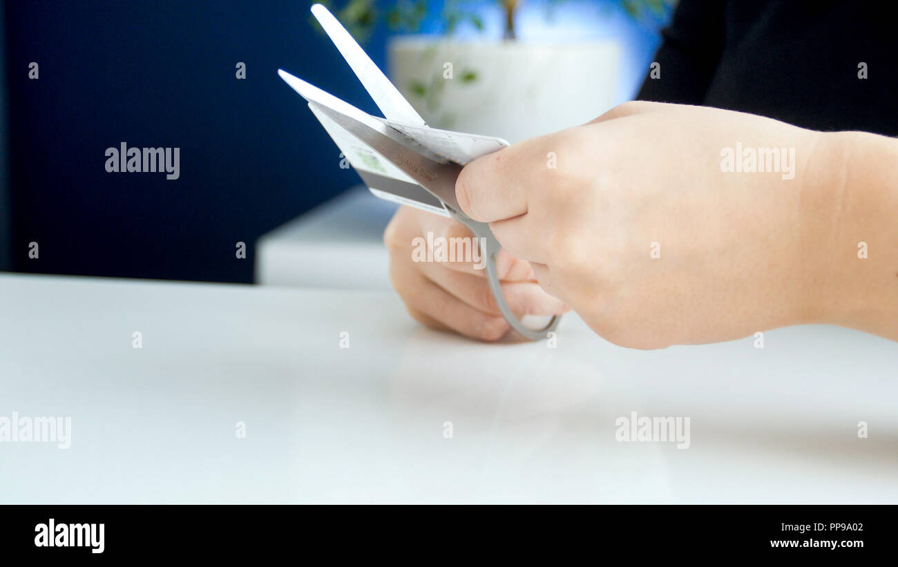Closeup image of woman destroying blocked credti card Stock Photo - Alamy