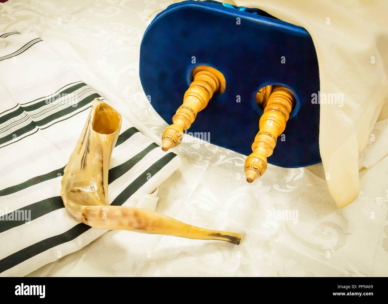 Torah scrolls, prayer shawl and a musical "shofar" horn used in the ...