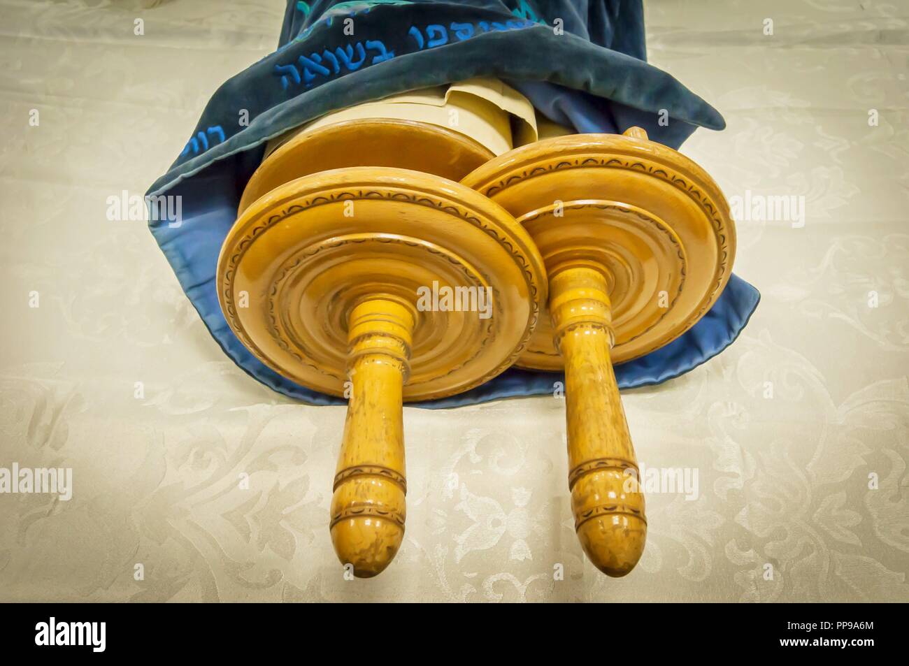 Classical Torah scrolls in a blue case with Hebrew letters. Torah is ...