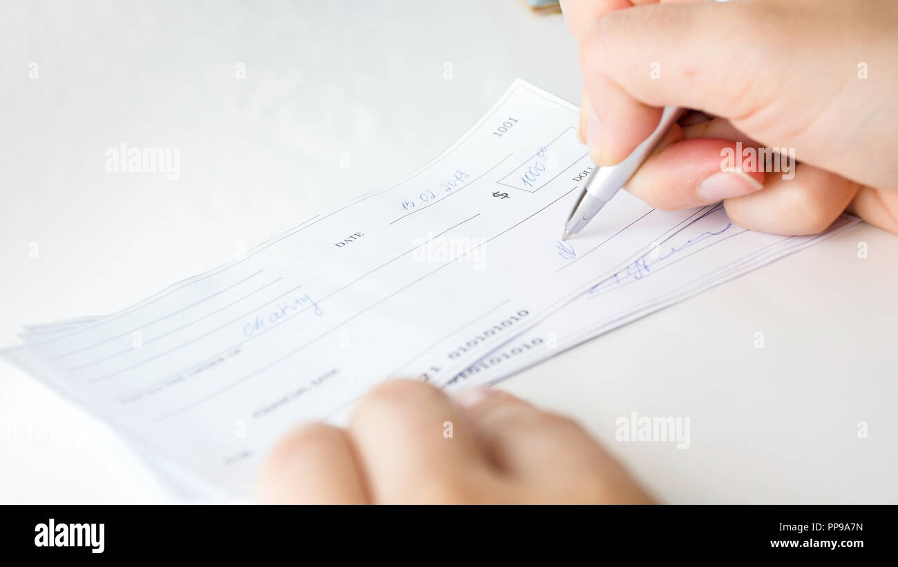 Closeup image of businesswoman putting her signature on personal bank ...