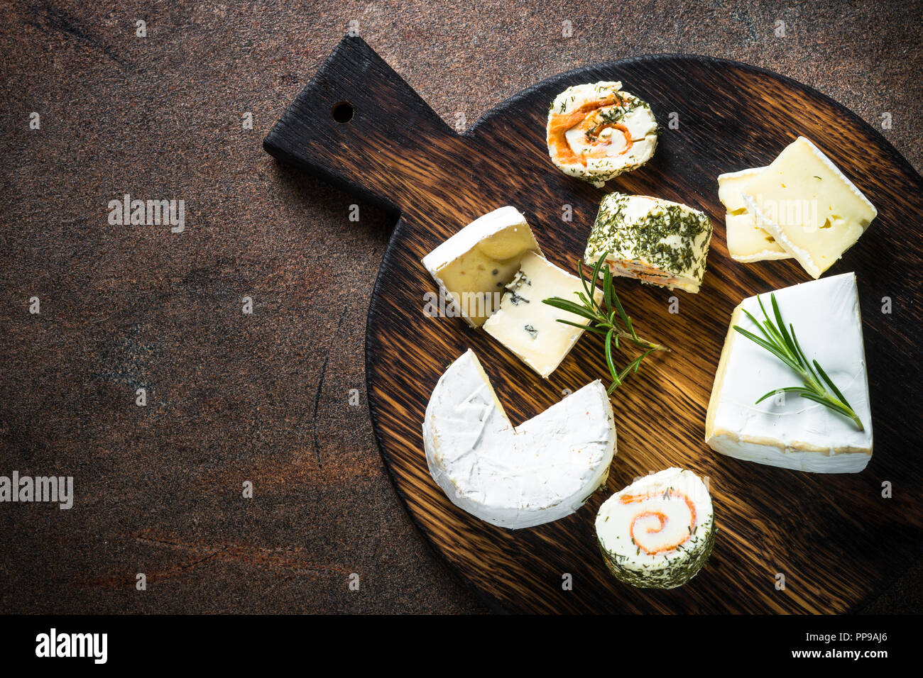 Cheese platter on dark stone table Stock Photo - Alamy