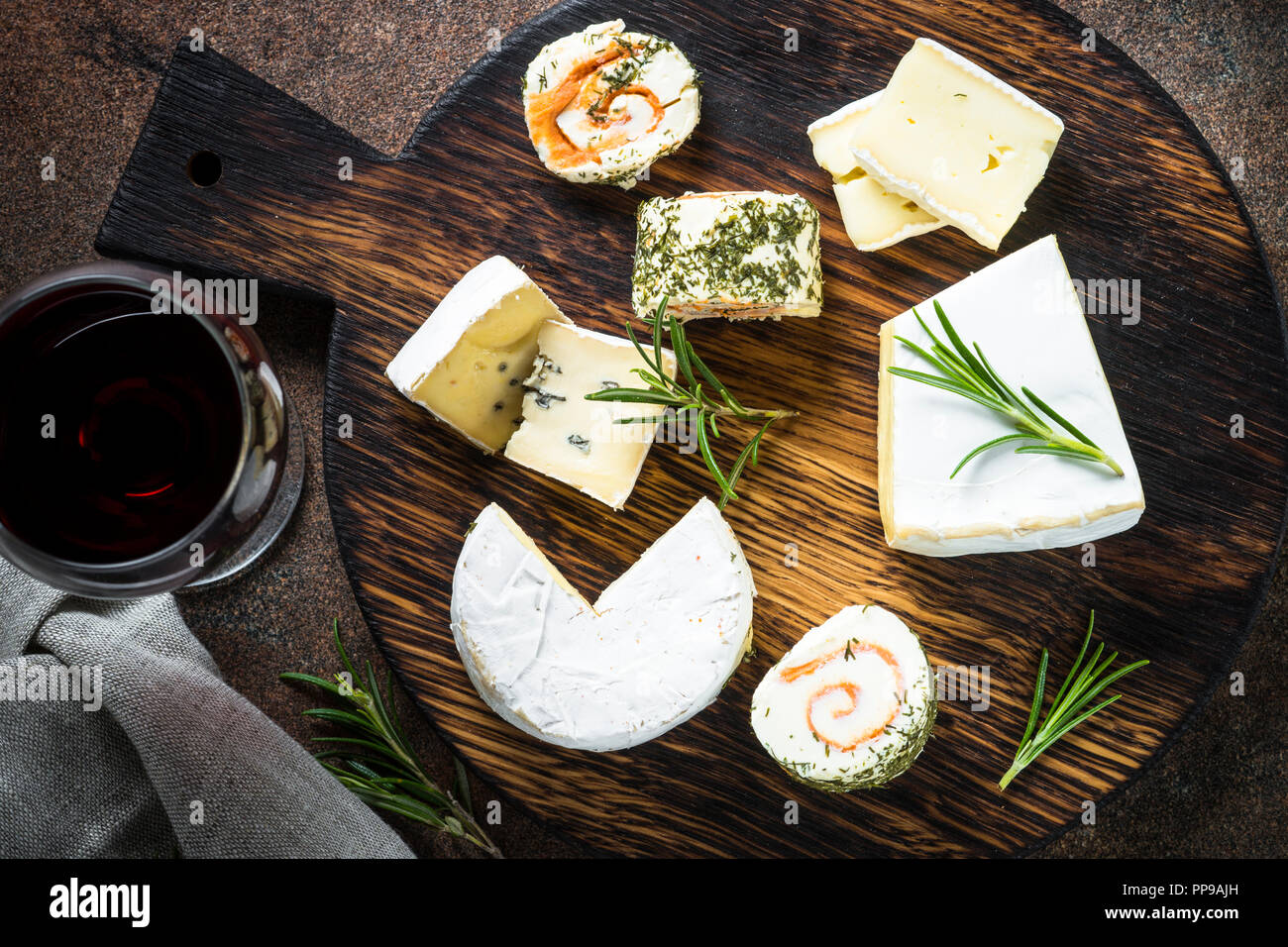 Cheese platter on dark stone table Stock Photo - Alamy