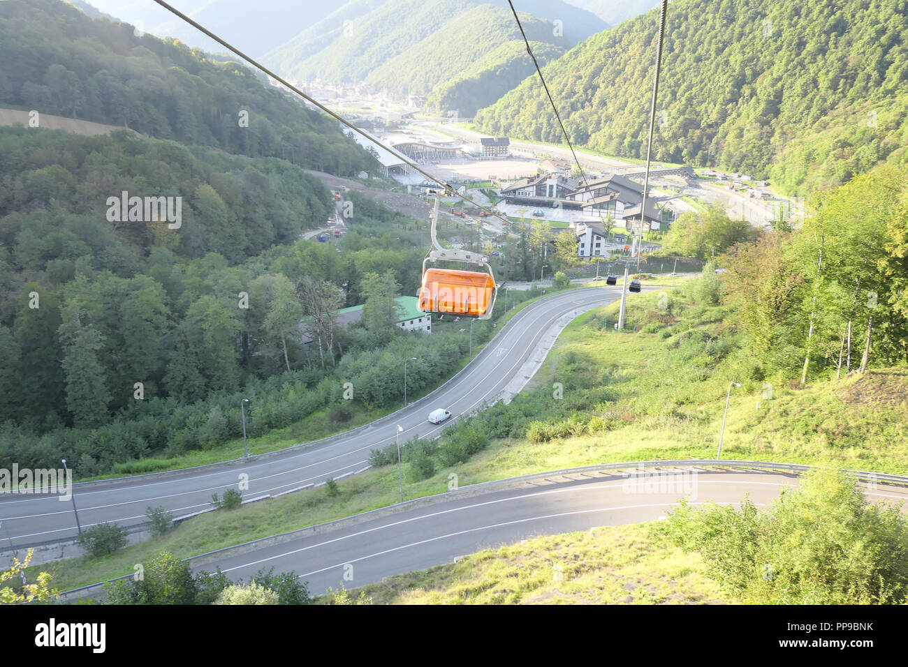 Cableway cabin riding on rope Stock Photo - Alamy