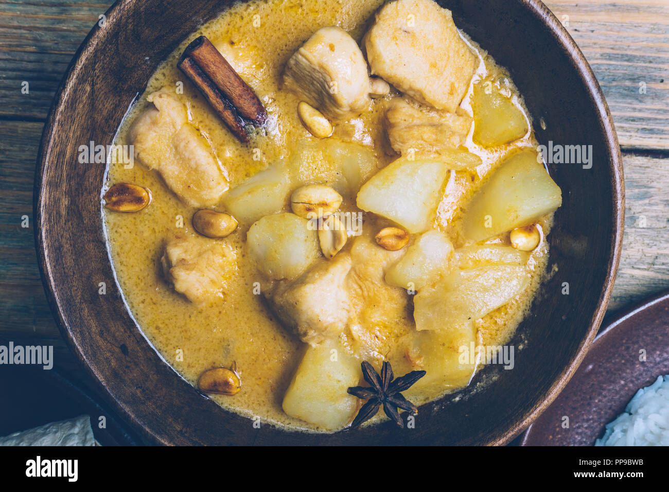 Thai massaman curry (chicken curry) with cinnamon sticks and plane riсe ...