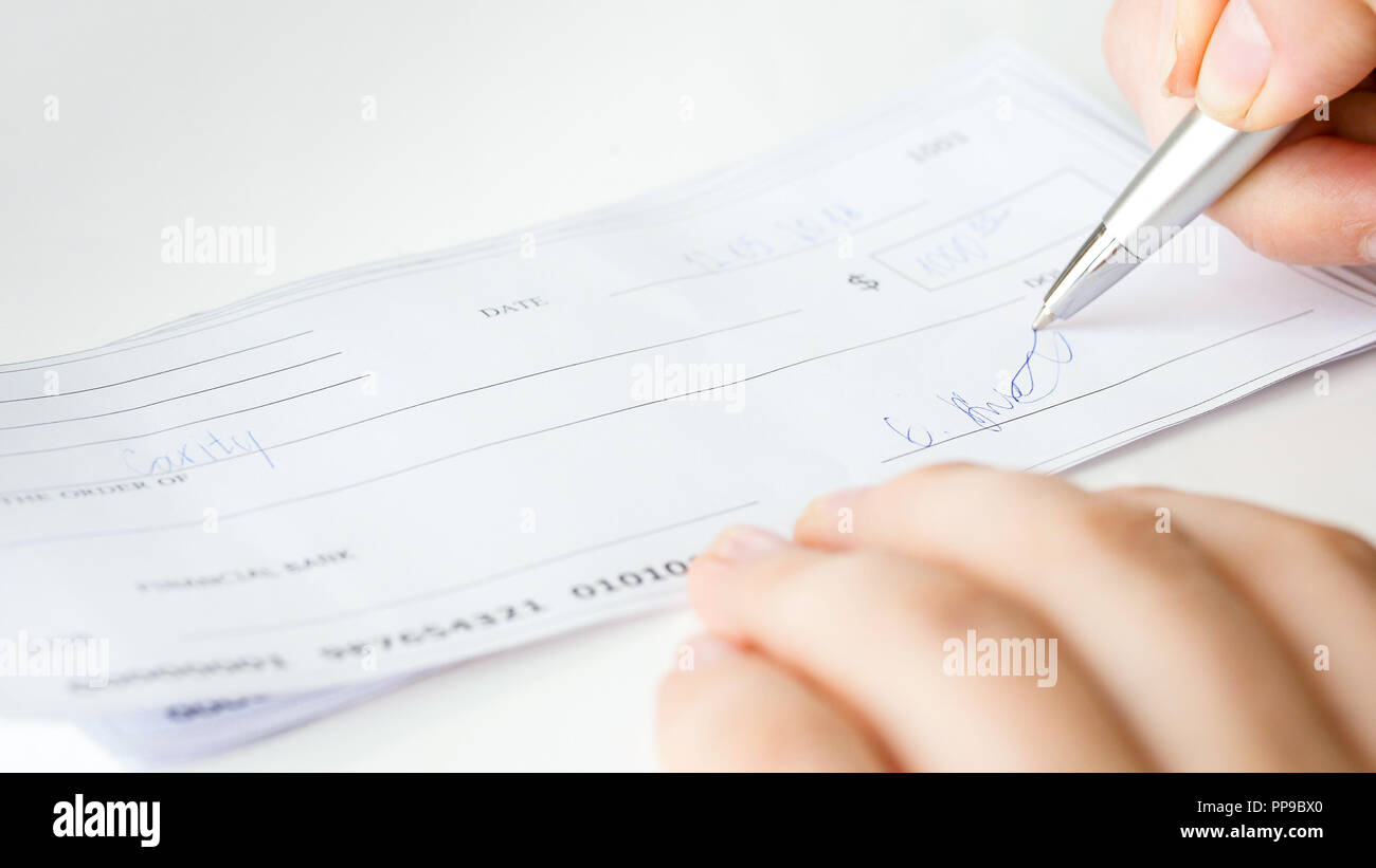 Man signing cheque hi-res stock photography and images - Alamy