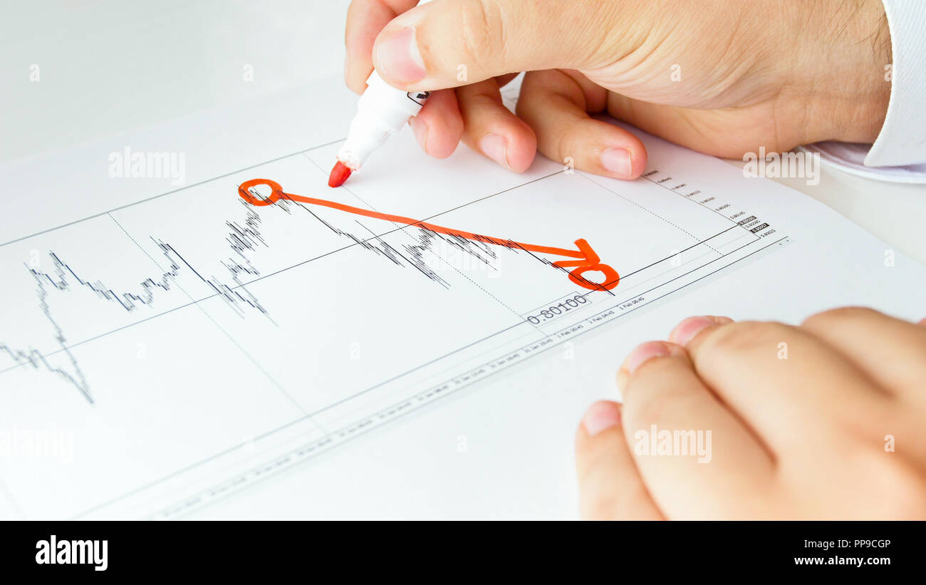 Closeup image of businessman drawing decreasing financial graph Stock ...