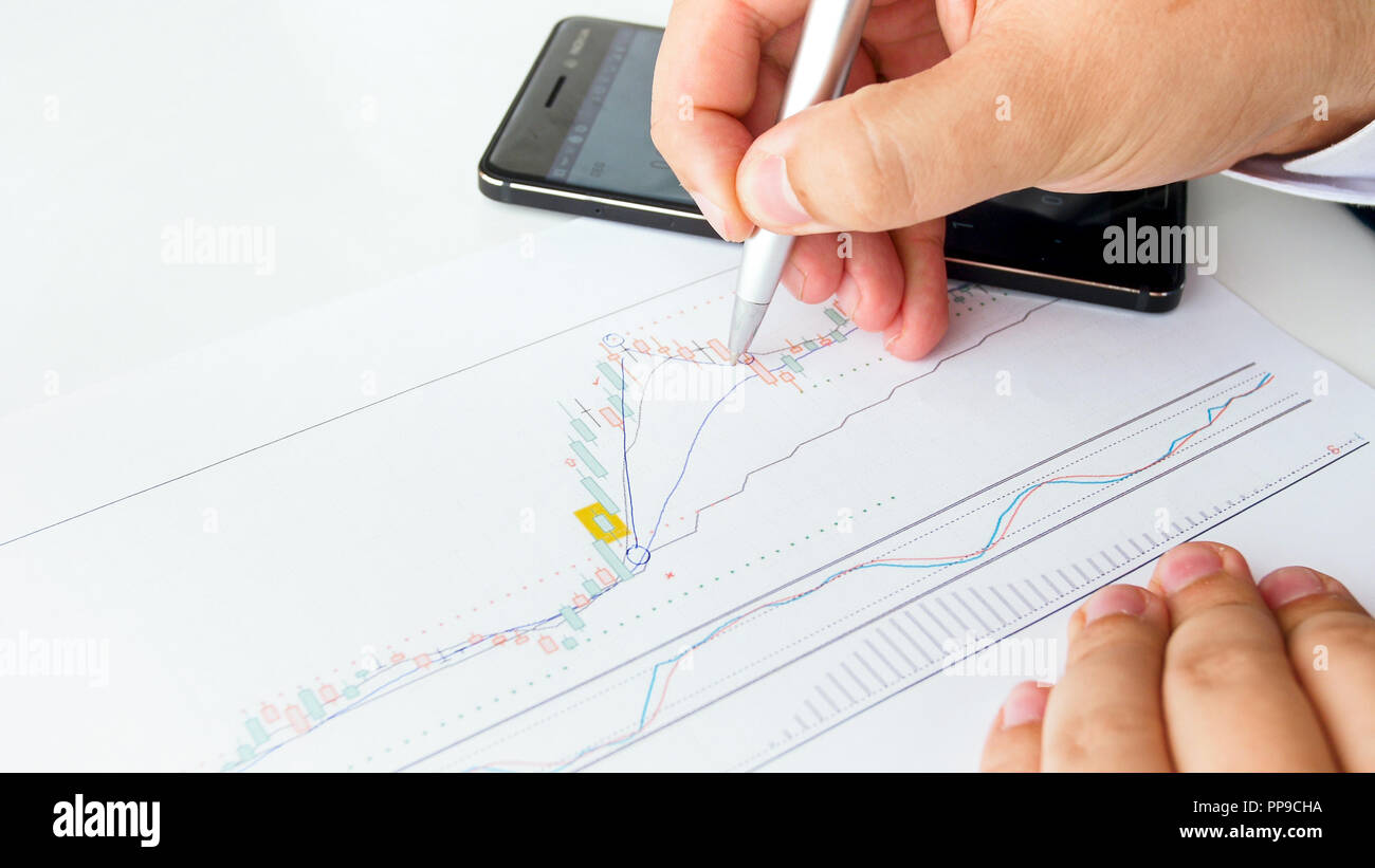 Closeup image of businessman analyzing stock sales rates using ...