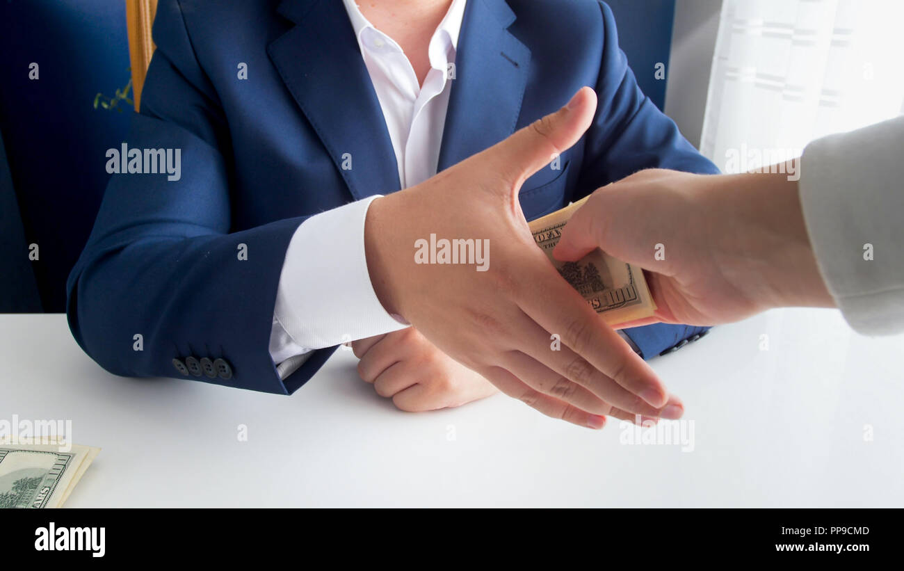 Closeup image of corrupted politician shaking hand with person and ...