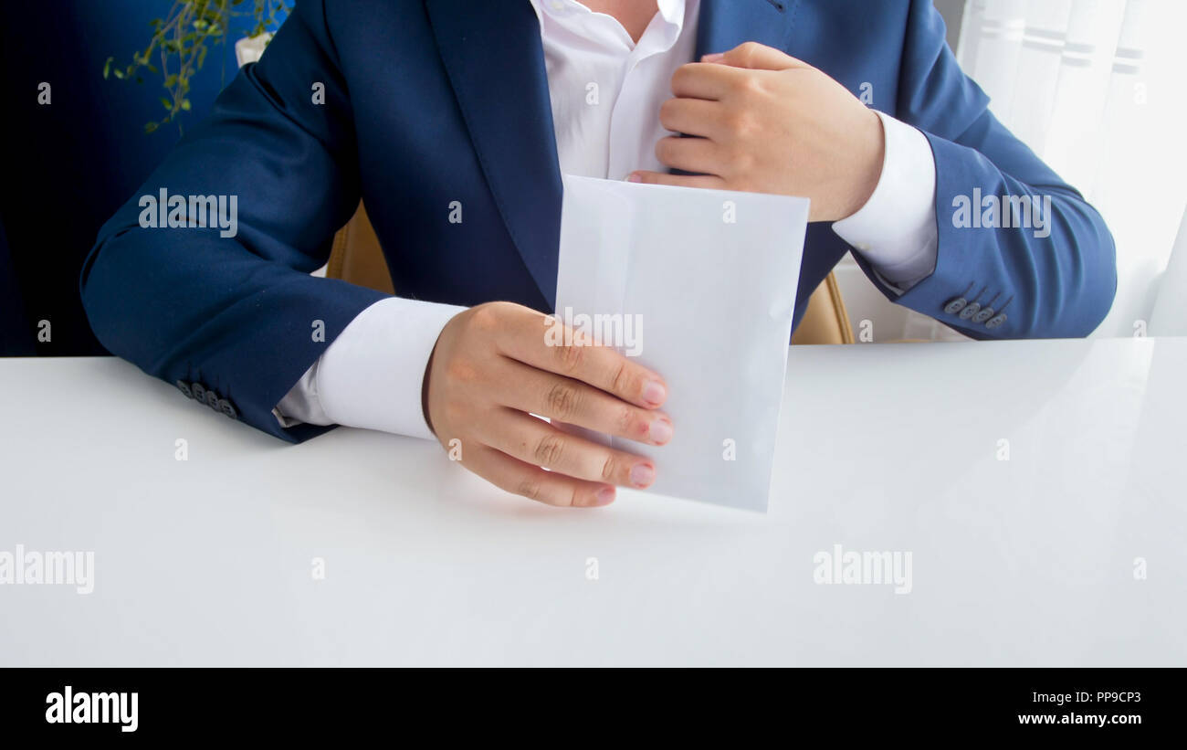 Closeup photo of businessman giving bribe in envelope Stock Photo - Alamy