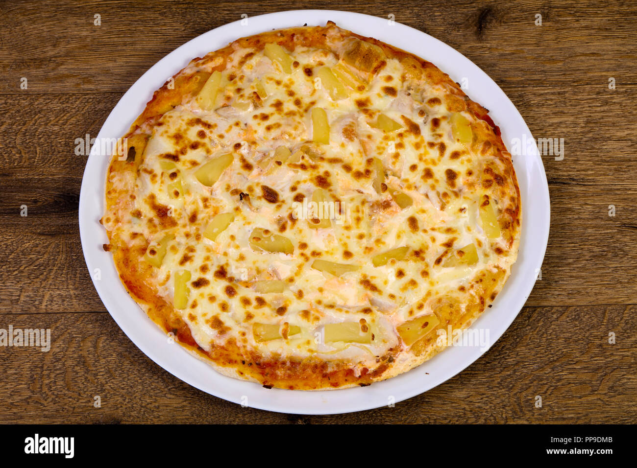 Pineapple pizza with soft cheese Stock Photo - Alamy