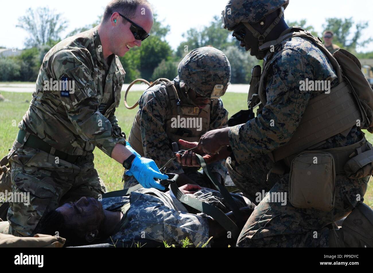 U.S. Marine and British medics quickly administer aid to simulated ...