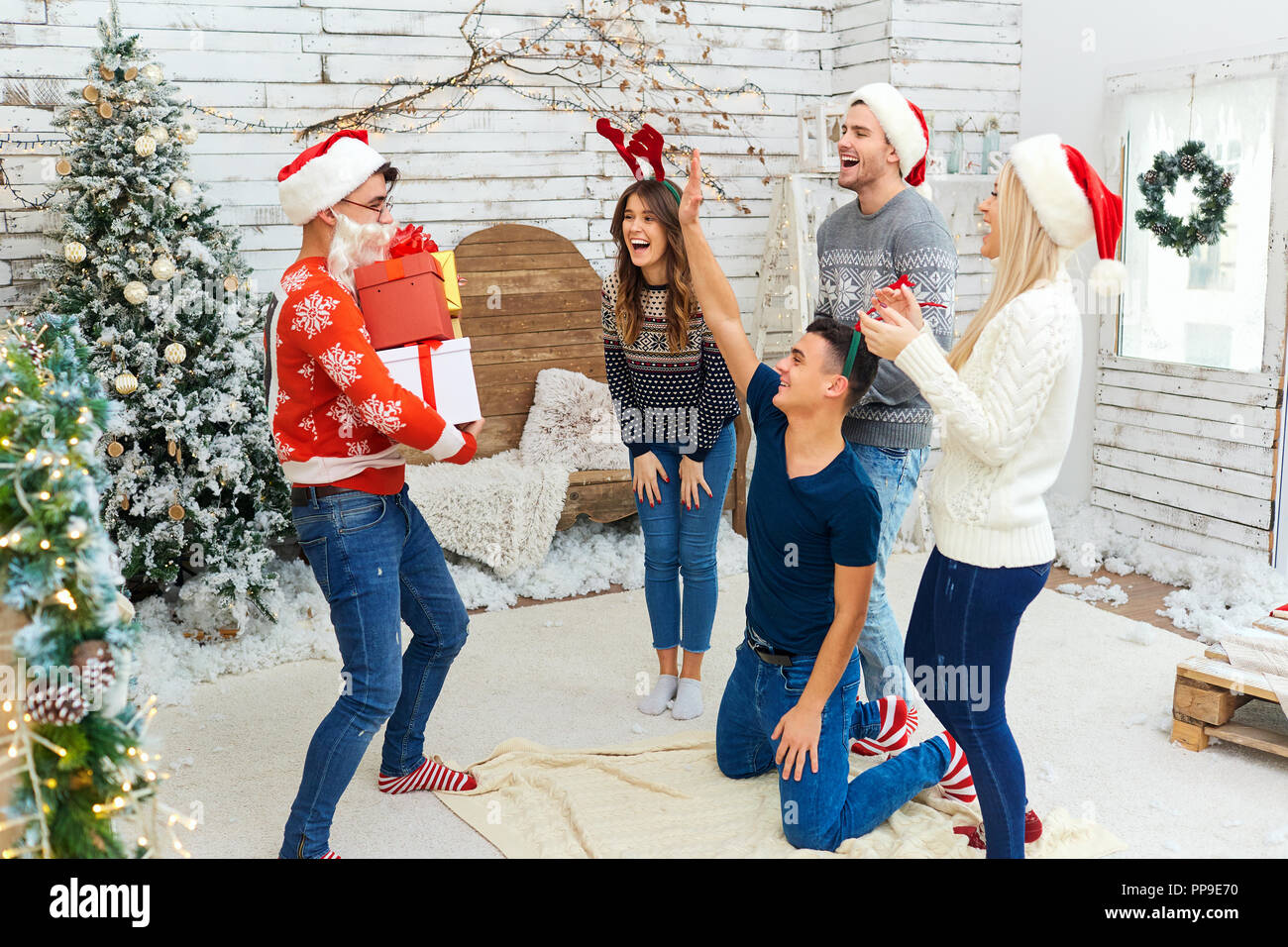 A group of friends with gifts at a Christmas party Stock Photo - Alamy
