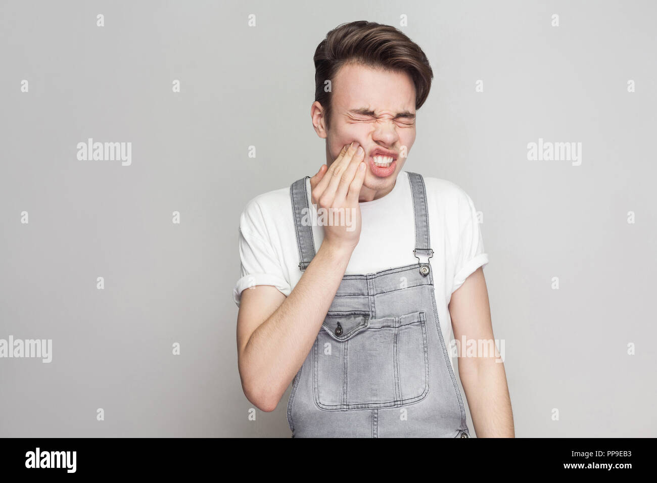 Portrait of sadness teenager having severe toothache and touching and ...