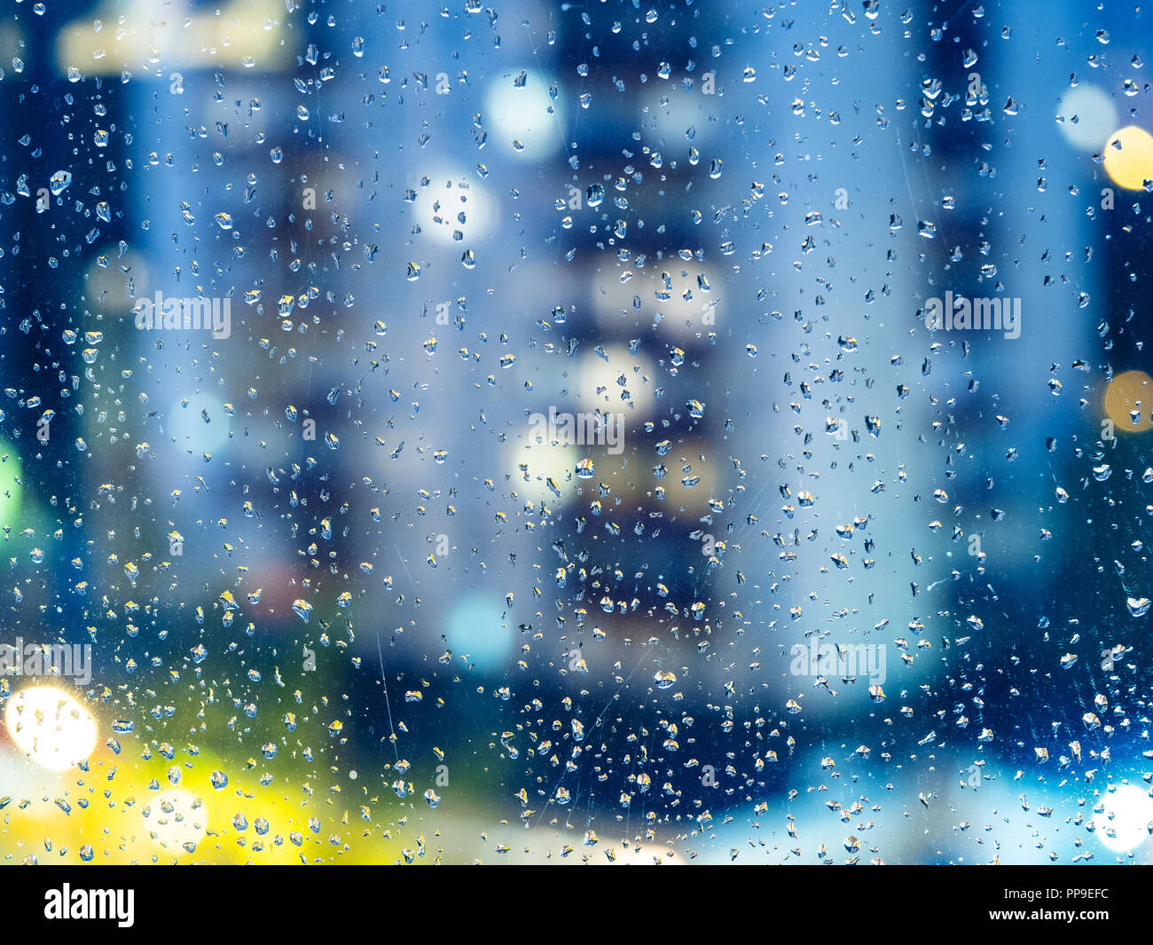 autumn rainy weather - view of blurred urban houses through the home ...