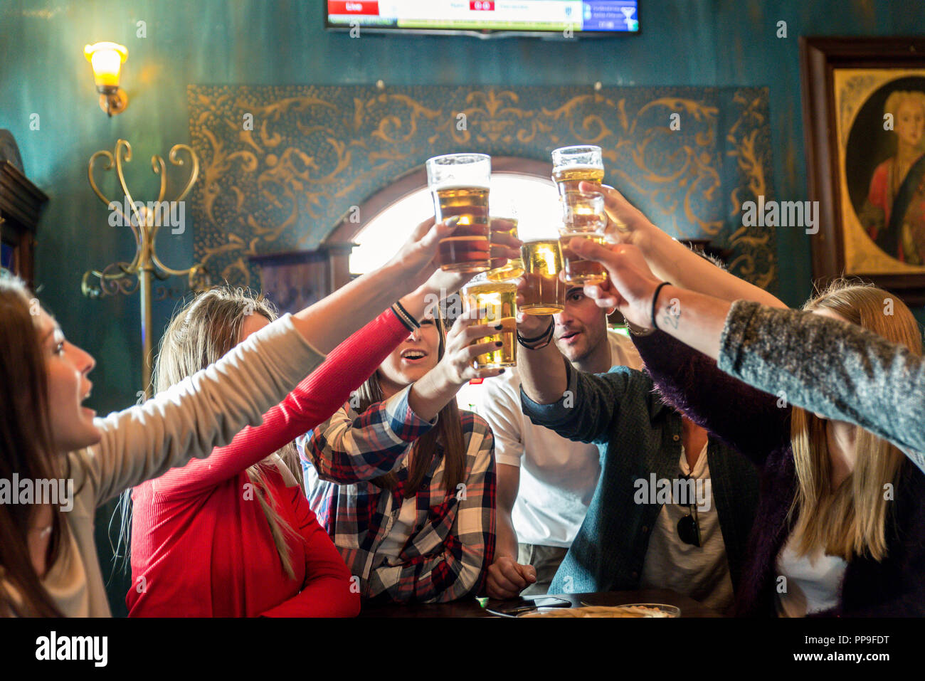 Group of happy friends having party in a bar - Young people drinking ...