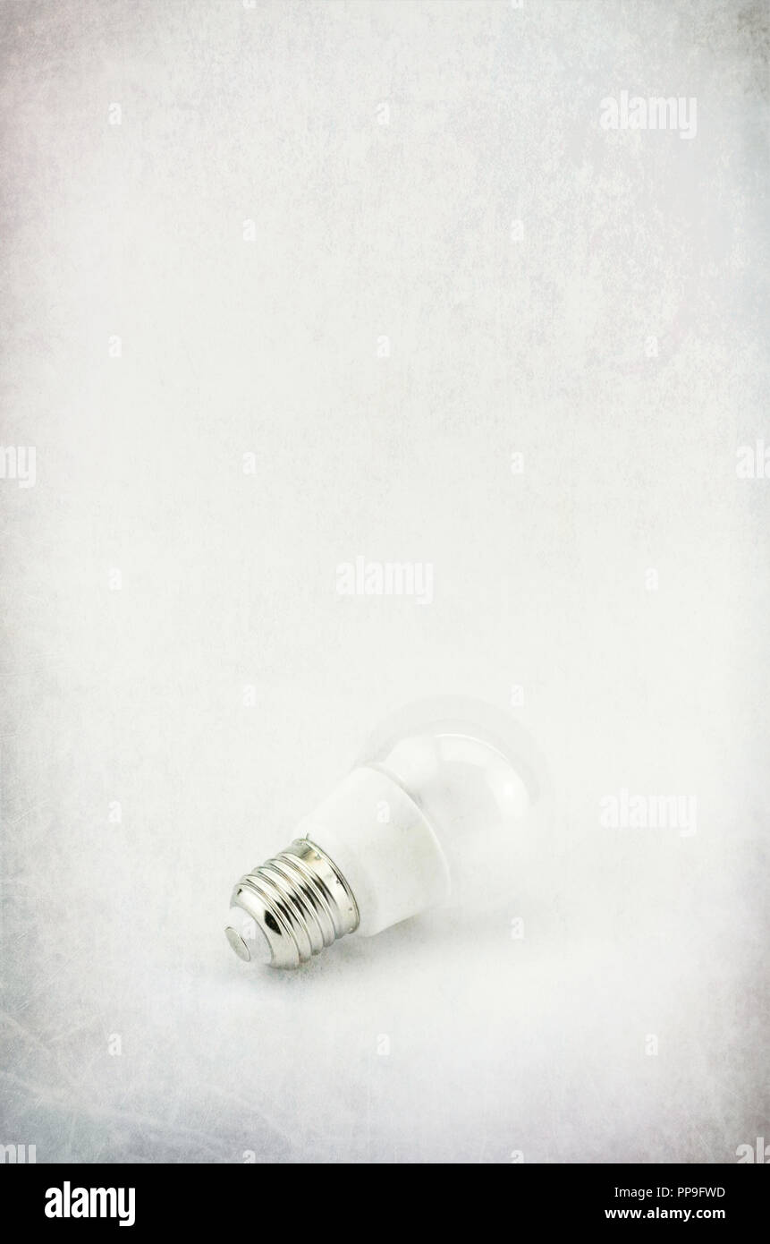 LED low power bulb on a white surface backdrop Stock Photo - Alamy