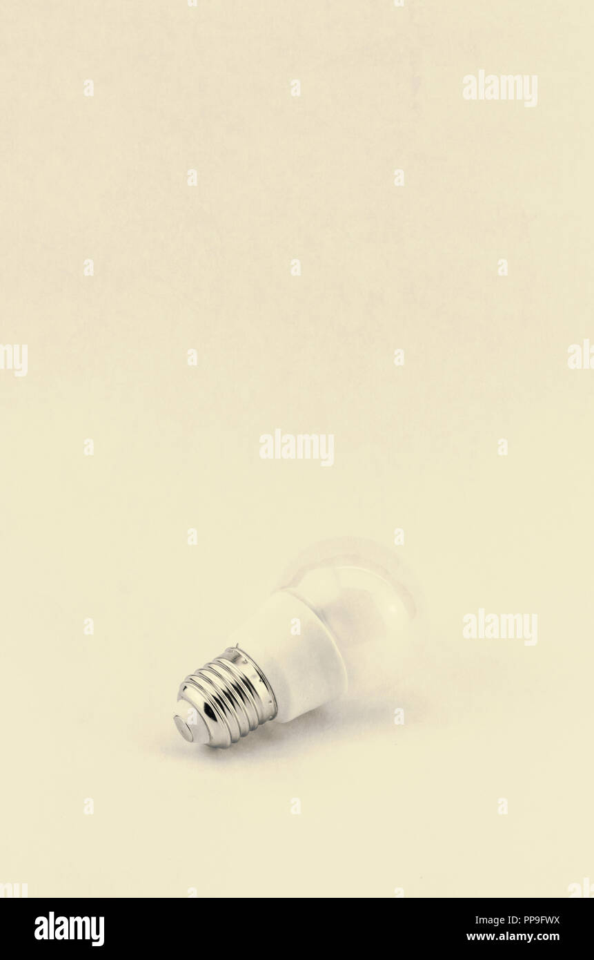 LED low power bulb on a white surface backdrop Stock Photo - Alamy
