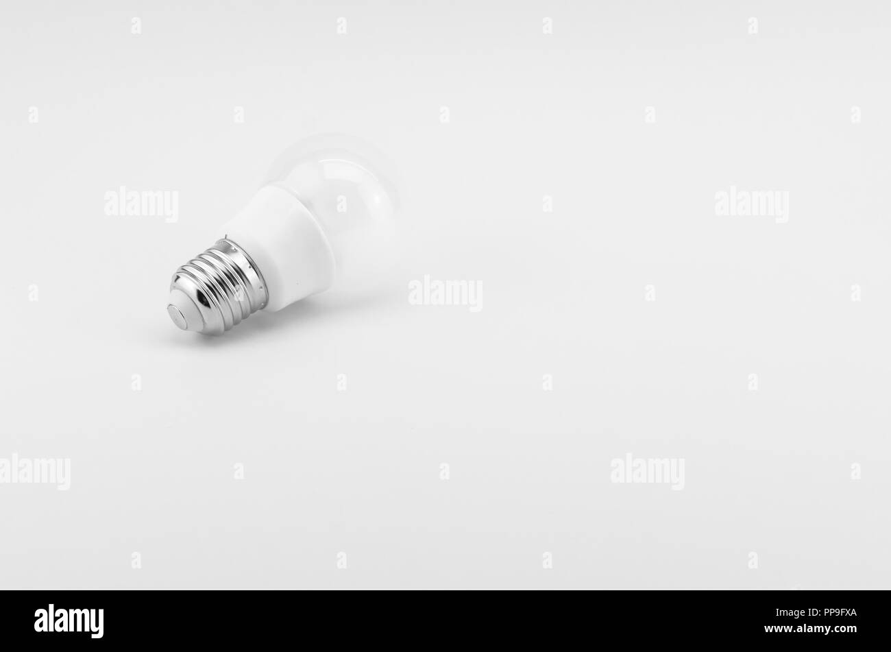 LED low power bulb on a white surface backdrop Stock Photo - Alamy