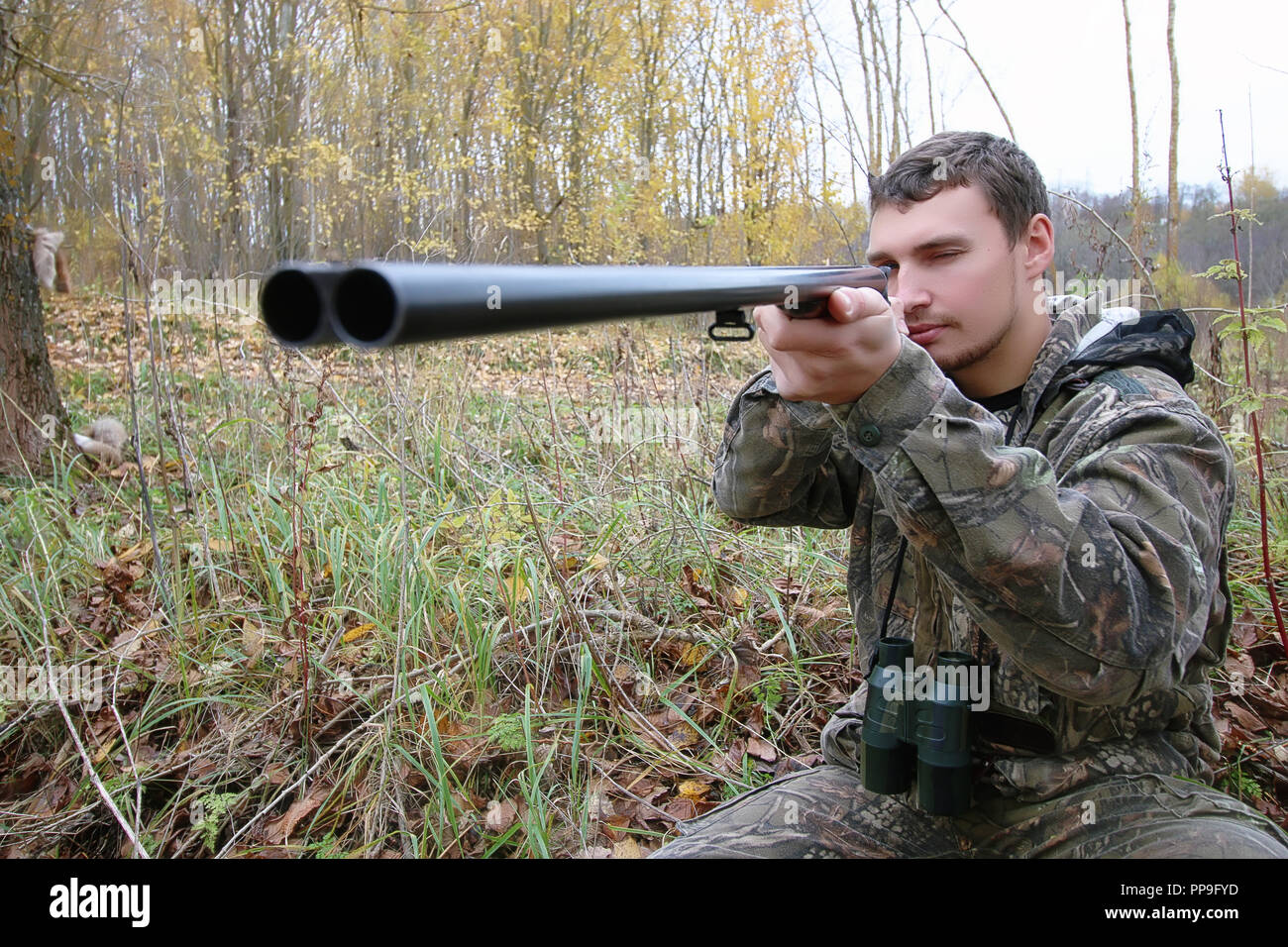 Man in camouflage and with guns in a forest belt on a spring hun Stock ...