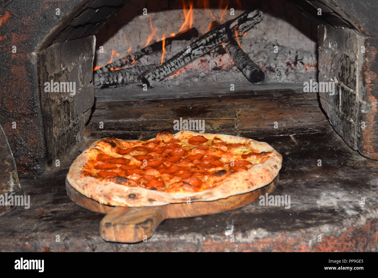 Fresh original Italian pizza is prepared and baked in a traditional ...