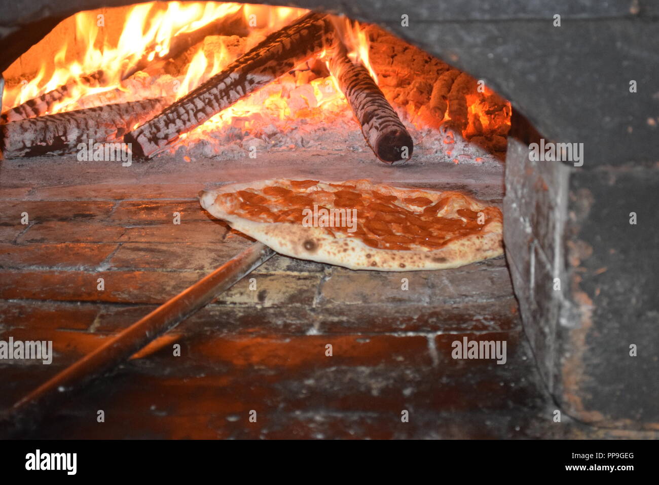 Fresh original Italian pizza is prepared and baked in a traditional ...