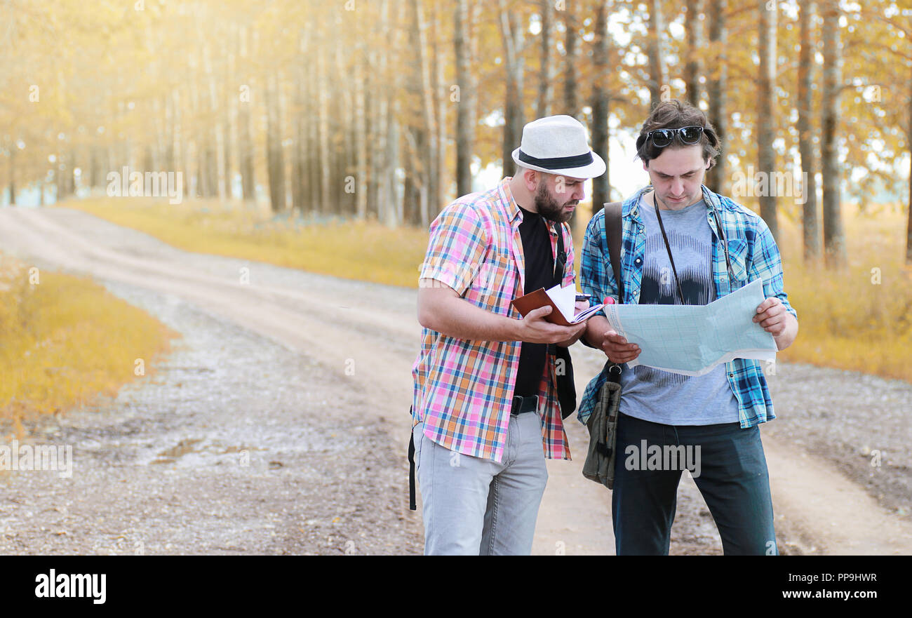 A young man looks at a map Stock Photo - Alamy