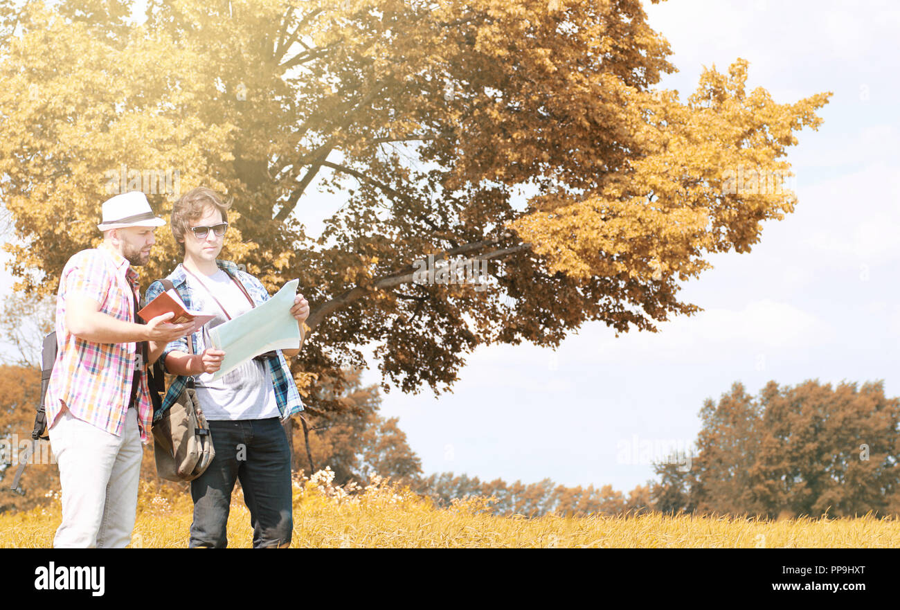 A young man looks at a map Stock Photo - Alamy