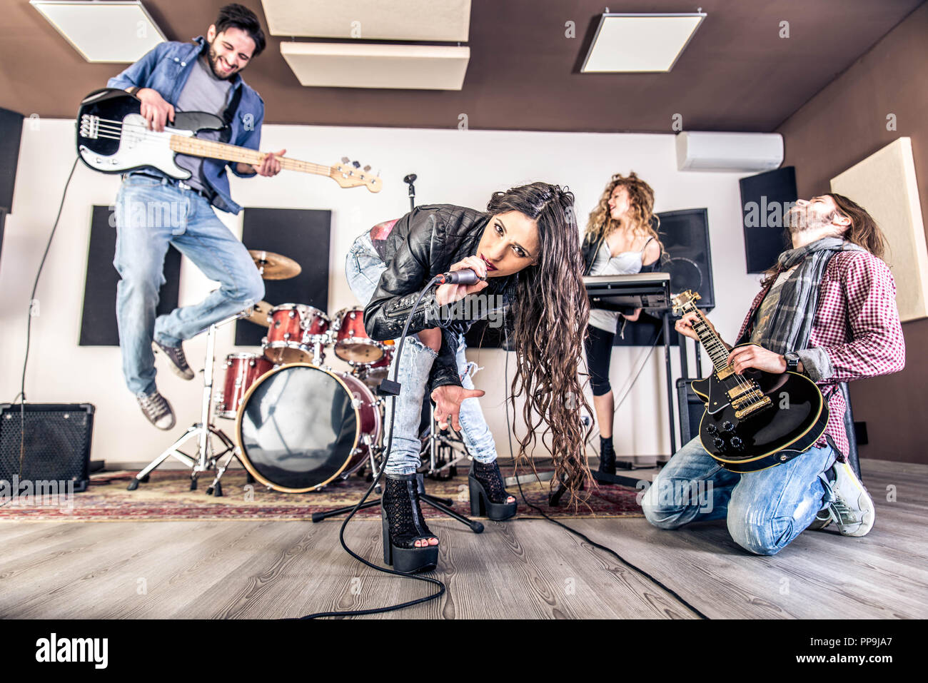 Rock band playing hard rock in the studio. Concept about entertainment ...