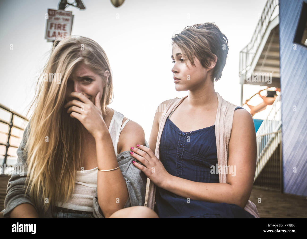 Young woman is sad crying and being consoled by friend Stock Photo - Alamy