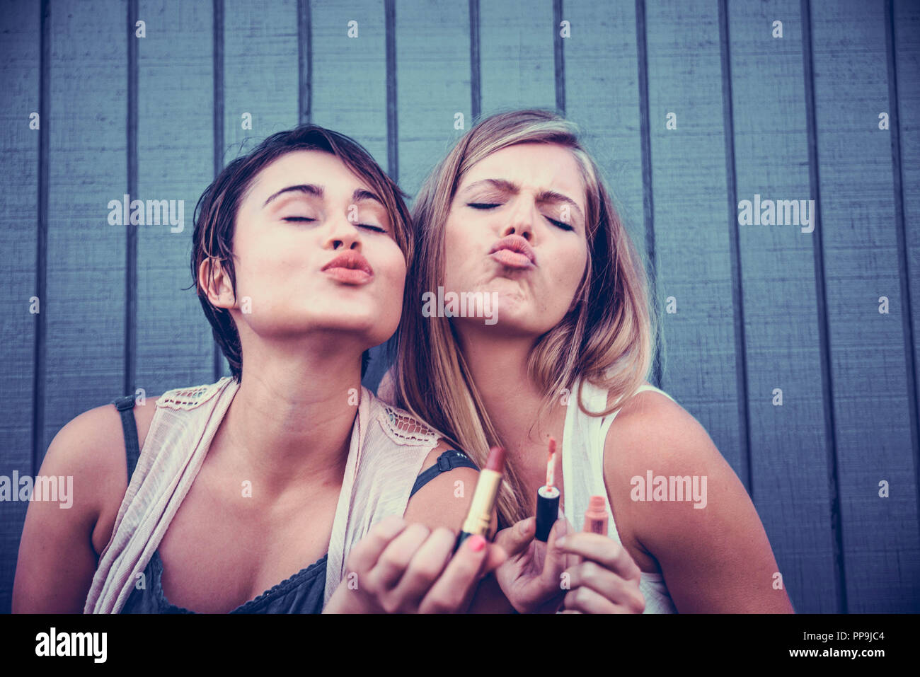 Two girls playing and having fun outdoors Stock Photo - Alamy