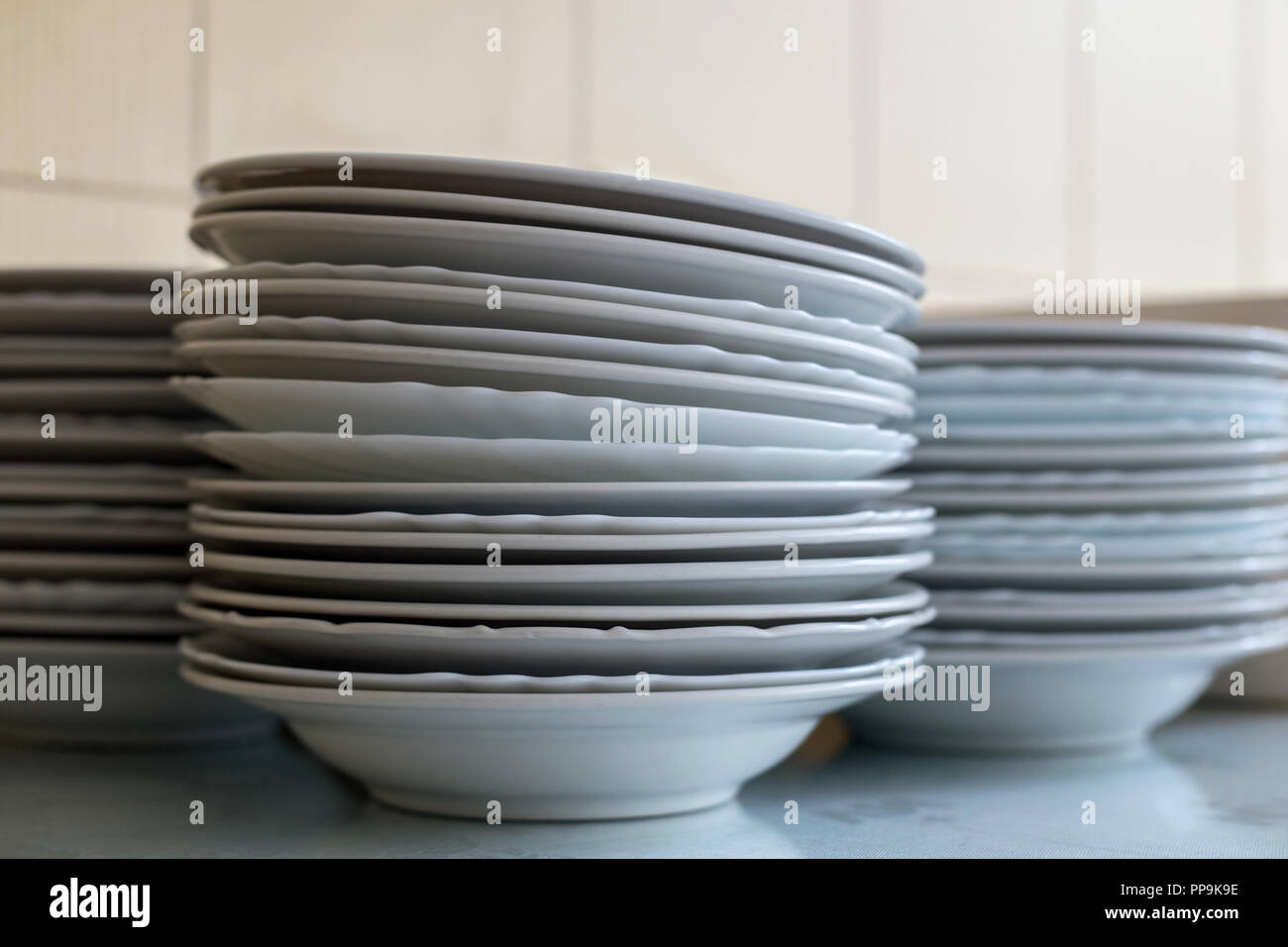 stack of white plates in the canteen Stock Photo - Alamy