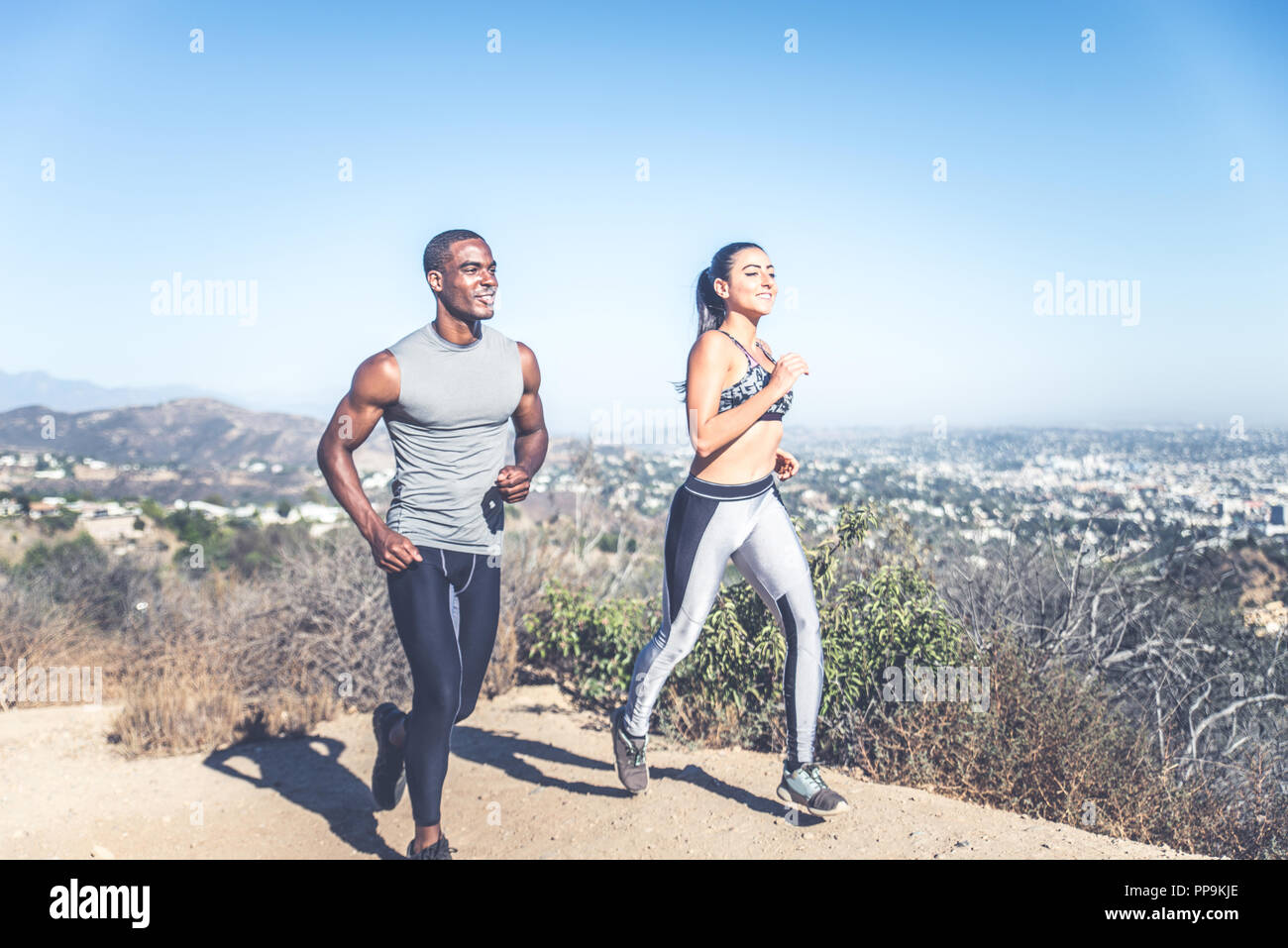 Multi-ethnic couple training in a canyon - Sportive boyfriend and ...