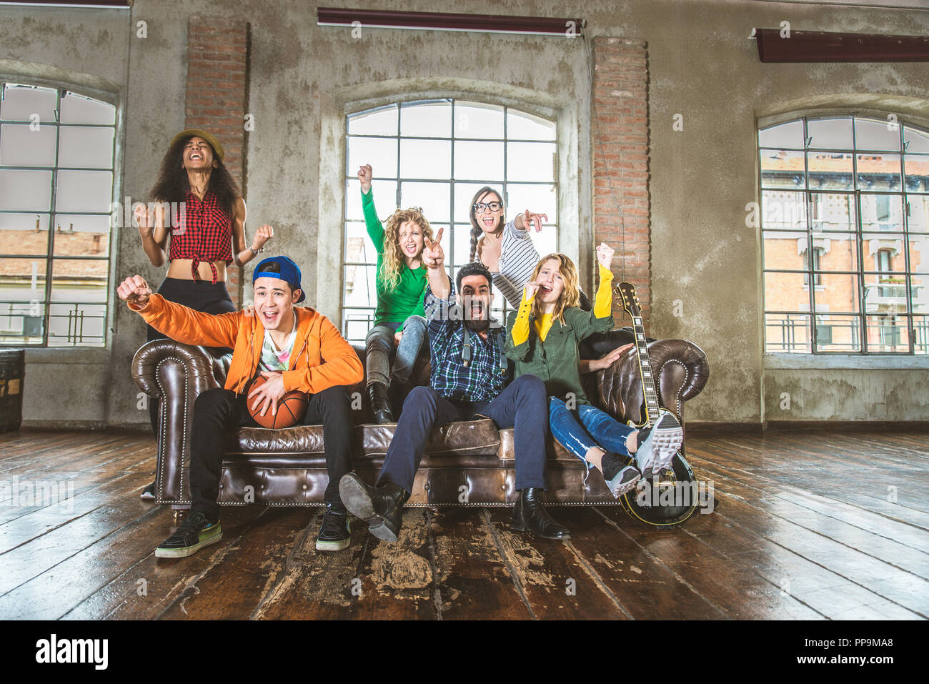 Mixed race group of teenagers having fun on the couch - Multi-ethnic ...