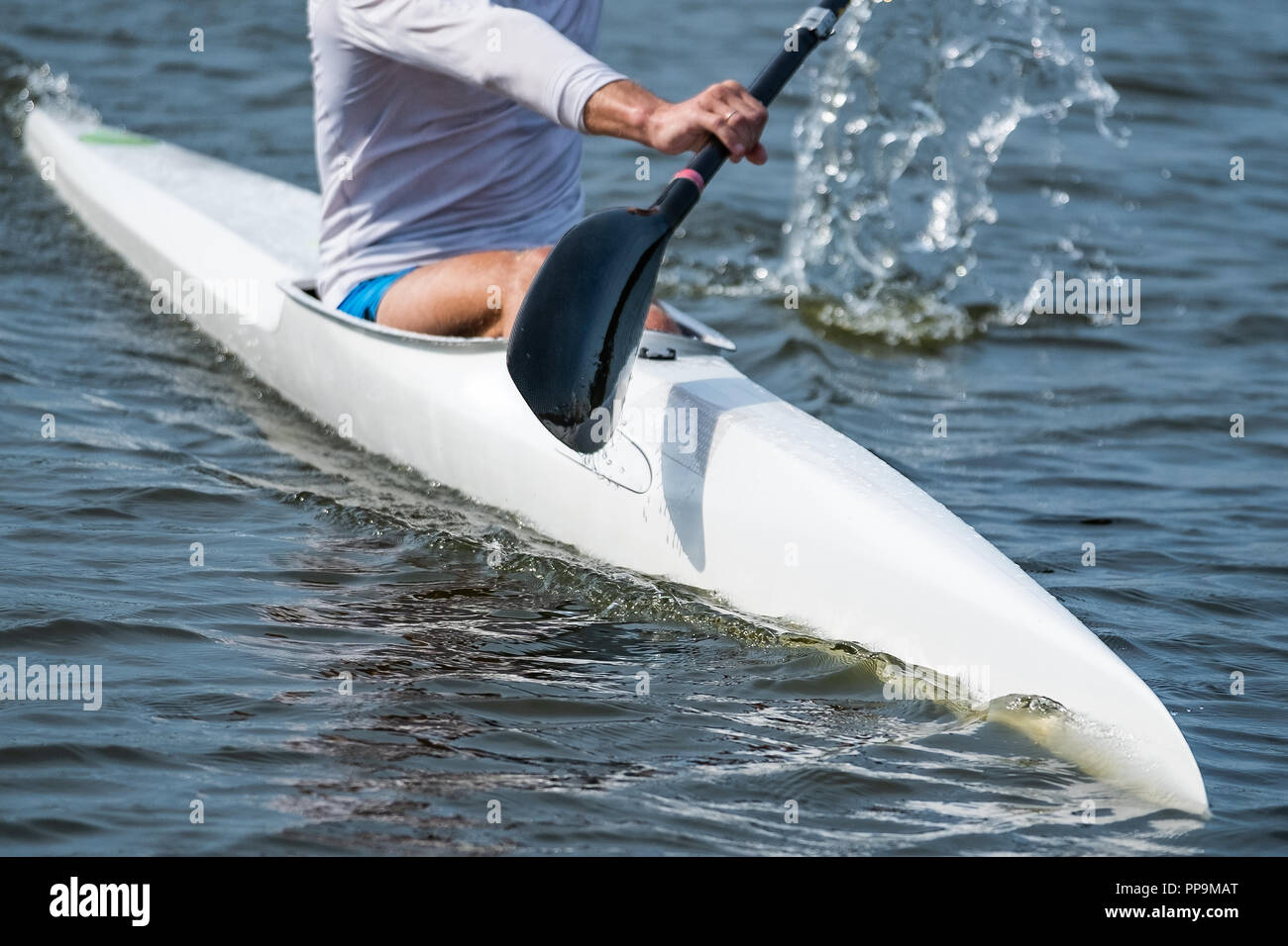 Photo of a part of a kayak with a paddle and a rower Stock Photo - Alamy